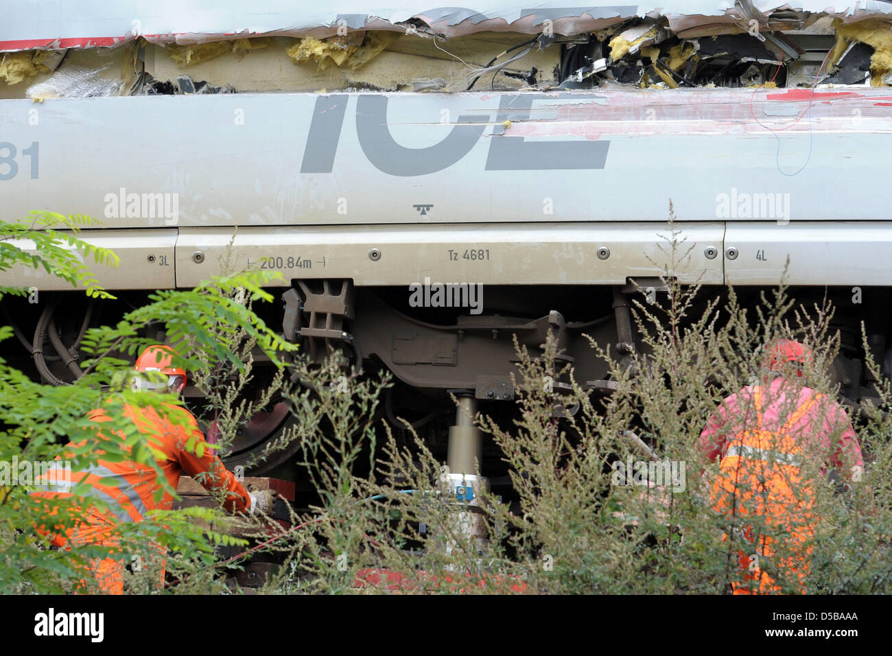 German rail workers inspect the damage on the side of an ICE highspeed ...