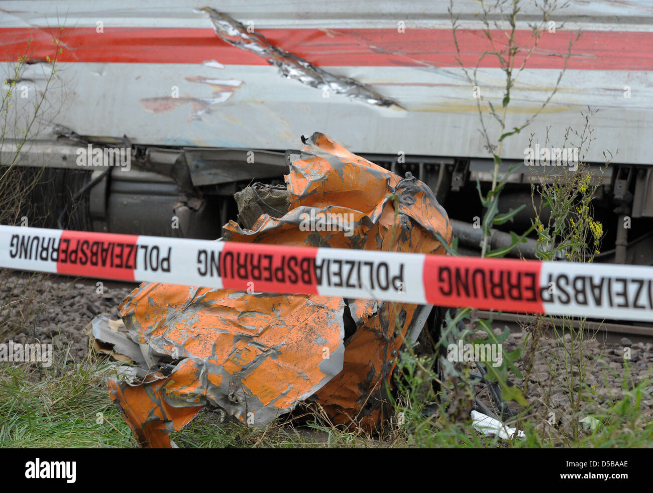 German rail workers inspect the damage on the side of an ICE highspeed ...