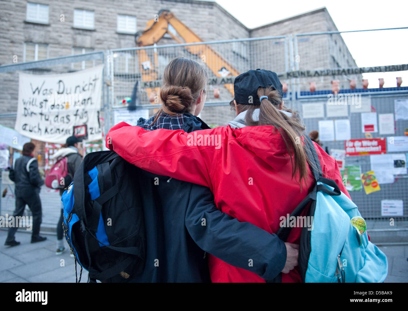 Two protesters hug in front of the cordoned-off area to the north of ...