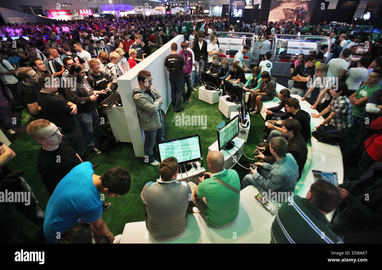 Visitors check out games at the Gamescom trade fair in Cologne, Germany ...