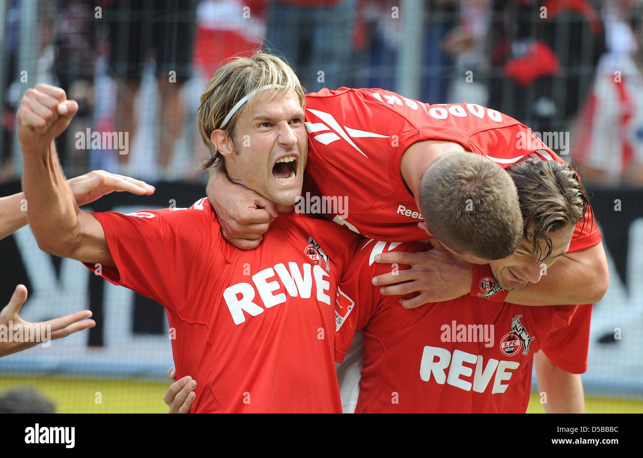 Cologne's Milivoje Novakovic (R) celebrates his 1-0 with team-mates ...