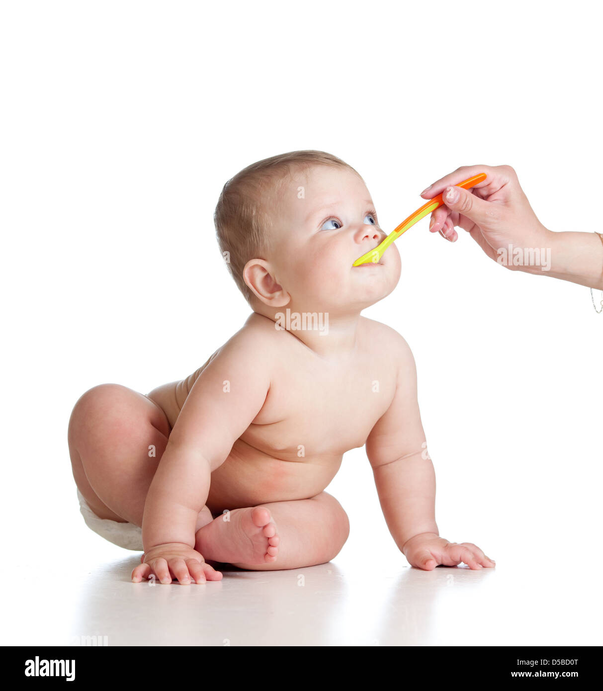 Mother's hand feeding baby with a spoon Stock Photo - Alamy