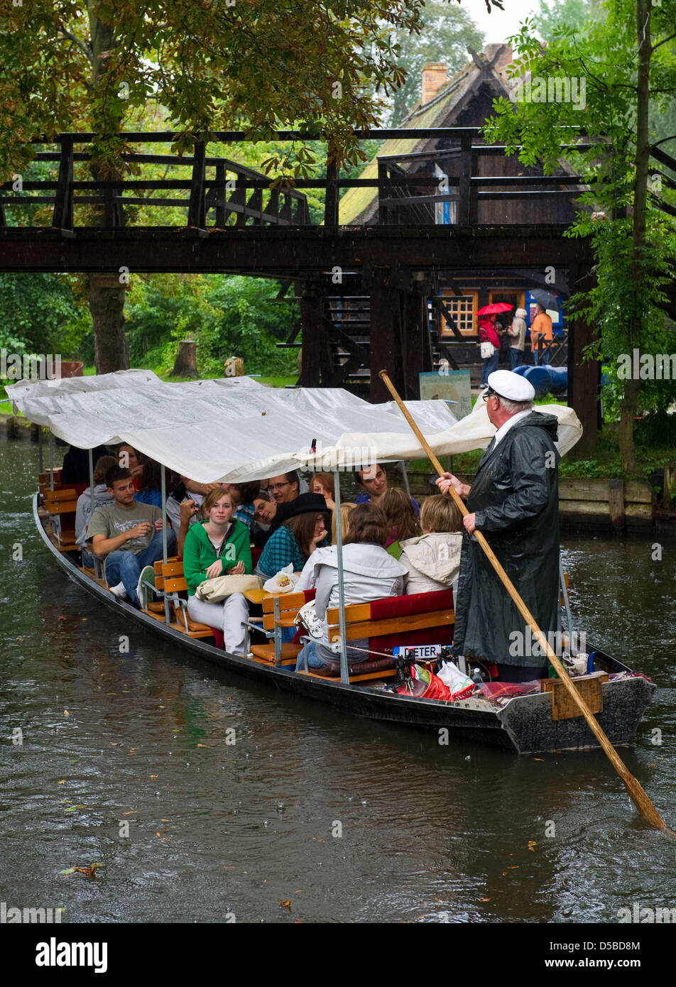 Despite rainfalls, tourists take a boat tour through the popular ...
