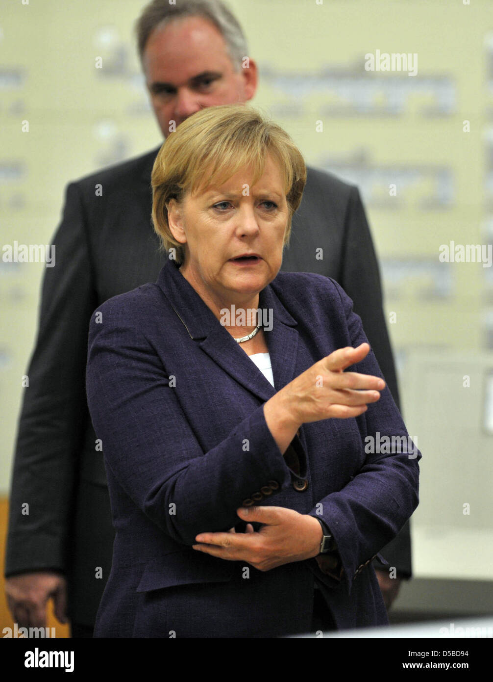 German chancellor Angela Merkel gestures in front of Chief Executive of ...