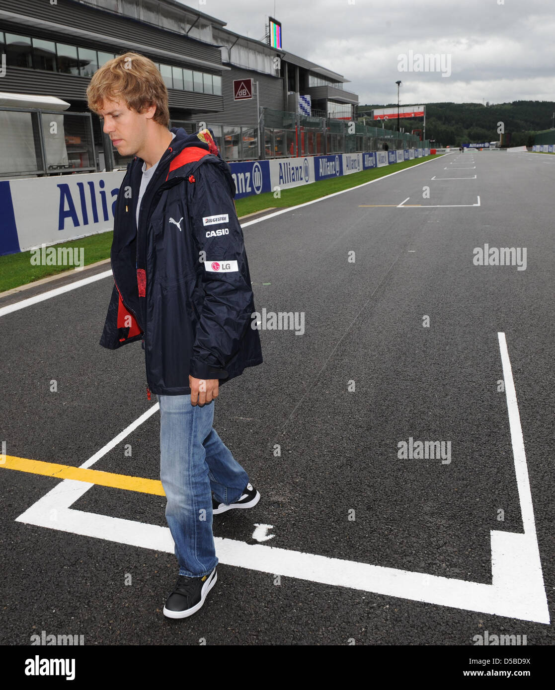 German driver Sebastian Vettel of Red Bull walks across the circuit in ...