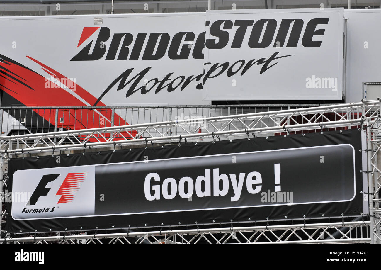 A sign saying 'Goodbye' is placed underneath a Bridgestone ...
