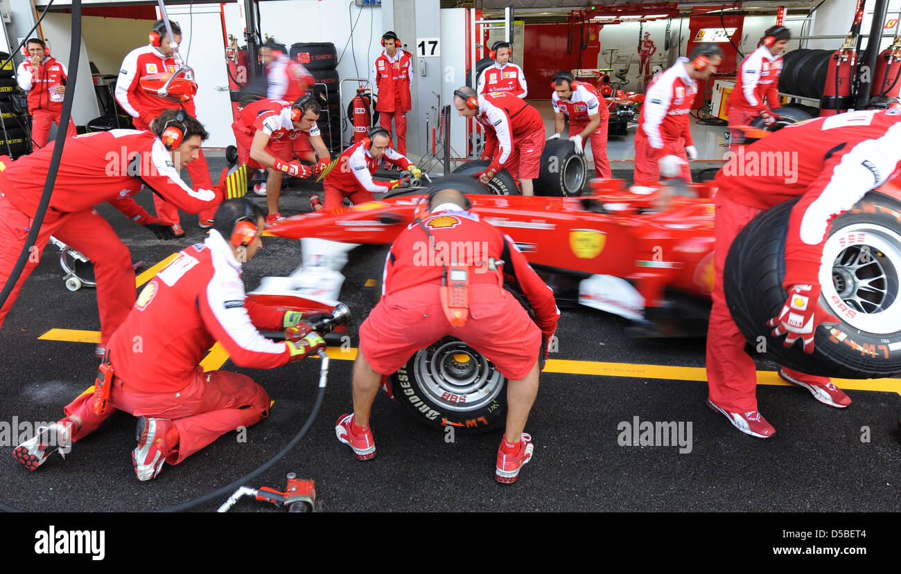 Ferrari mechanics train for a pit stop before the qualifying run at the ...