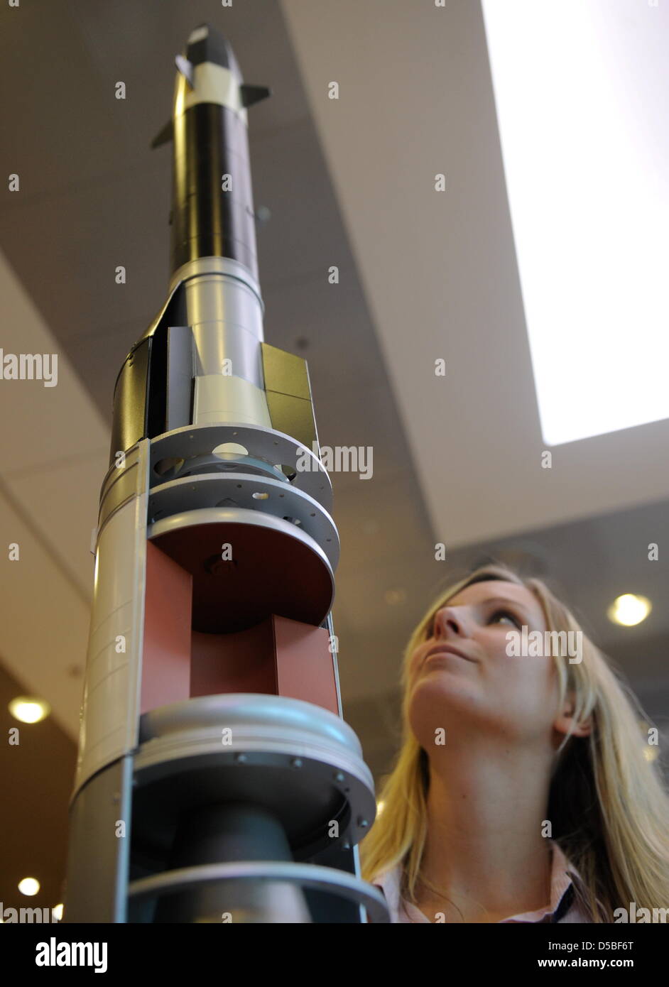 A woman examines a rocket model at the stand of the German Aerospace ...