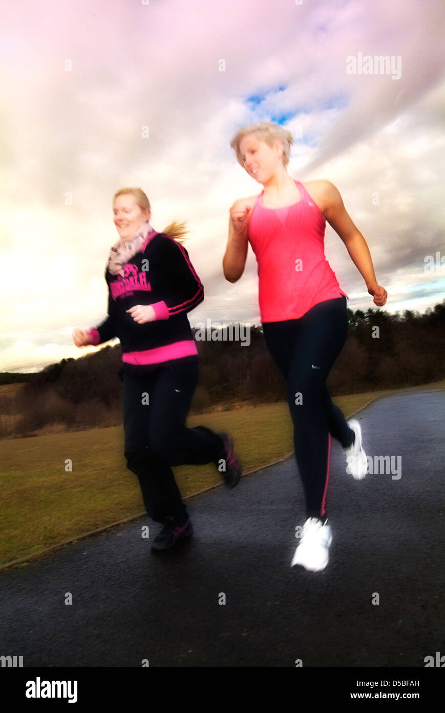 Two girls running in the park Stock Photo - Alamy