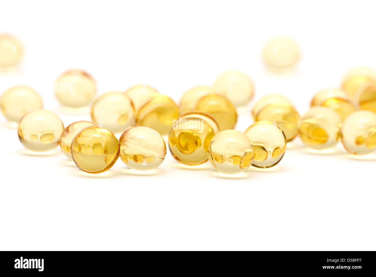 Transparent yellow capsules isolated on white Stock Photo - Alamy