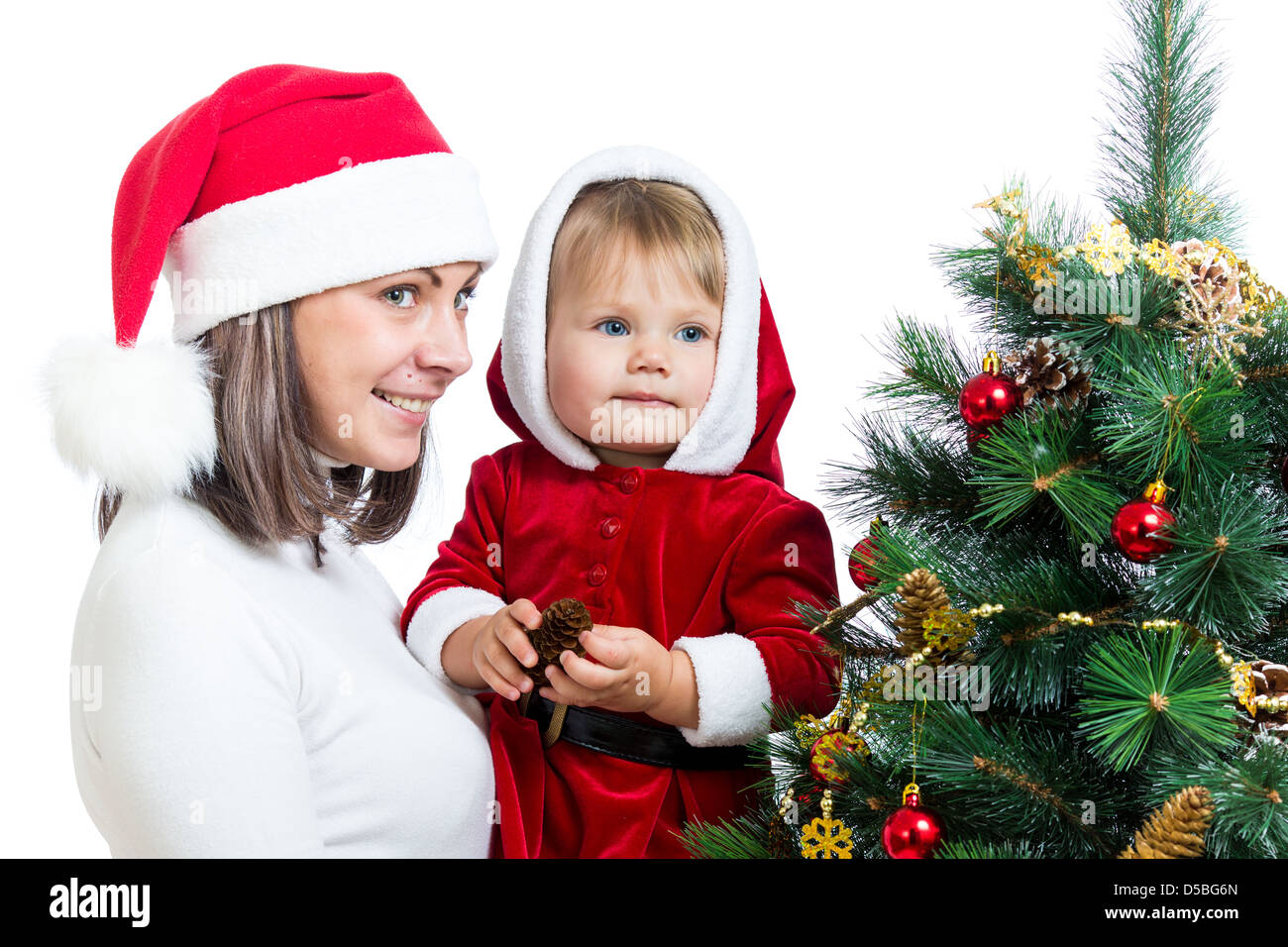 baby in Santa Claus clothes and mother on bright festive background ...