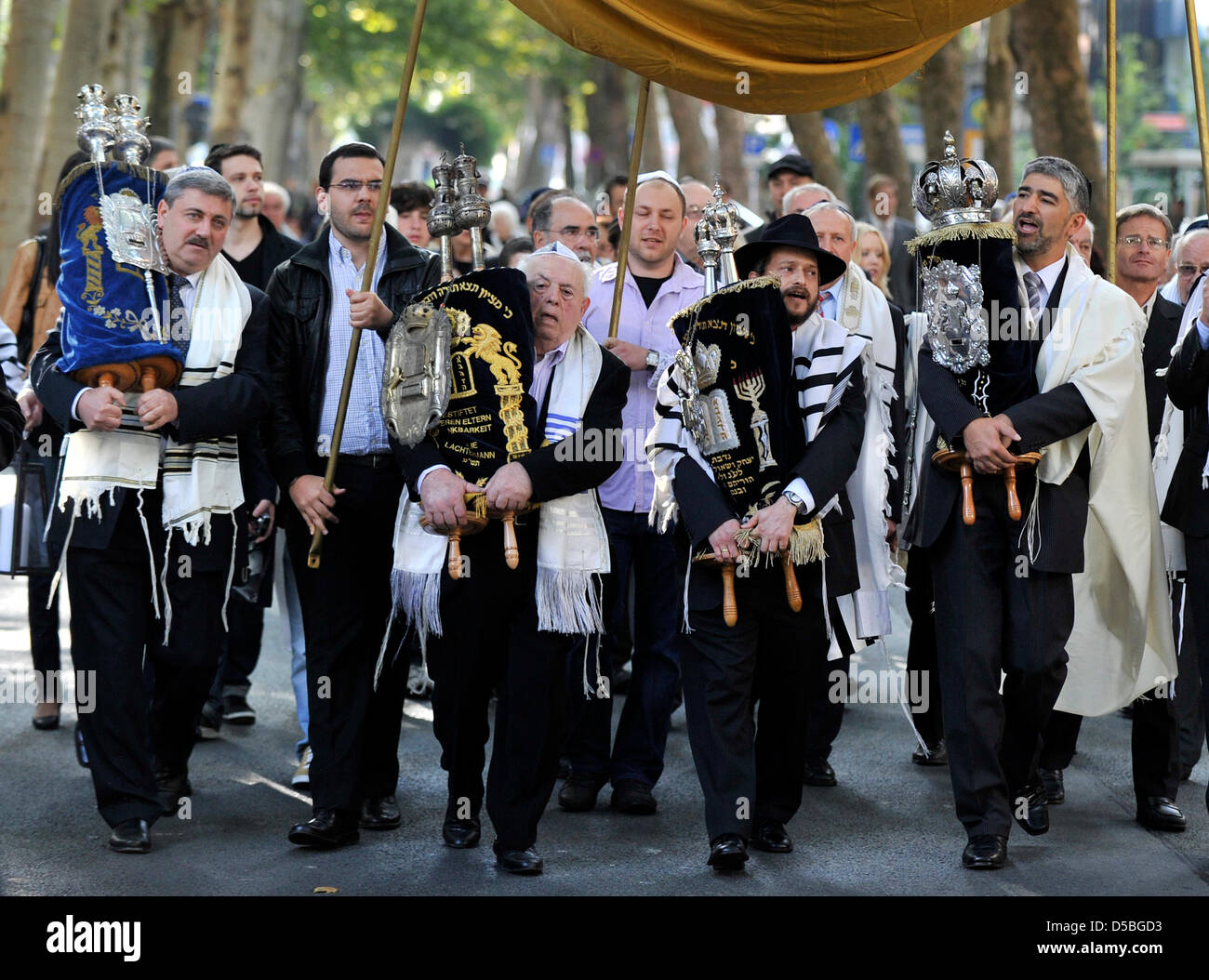 Jews carry Torah scrolls from the old synagogue to the new one during a ...