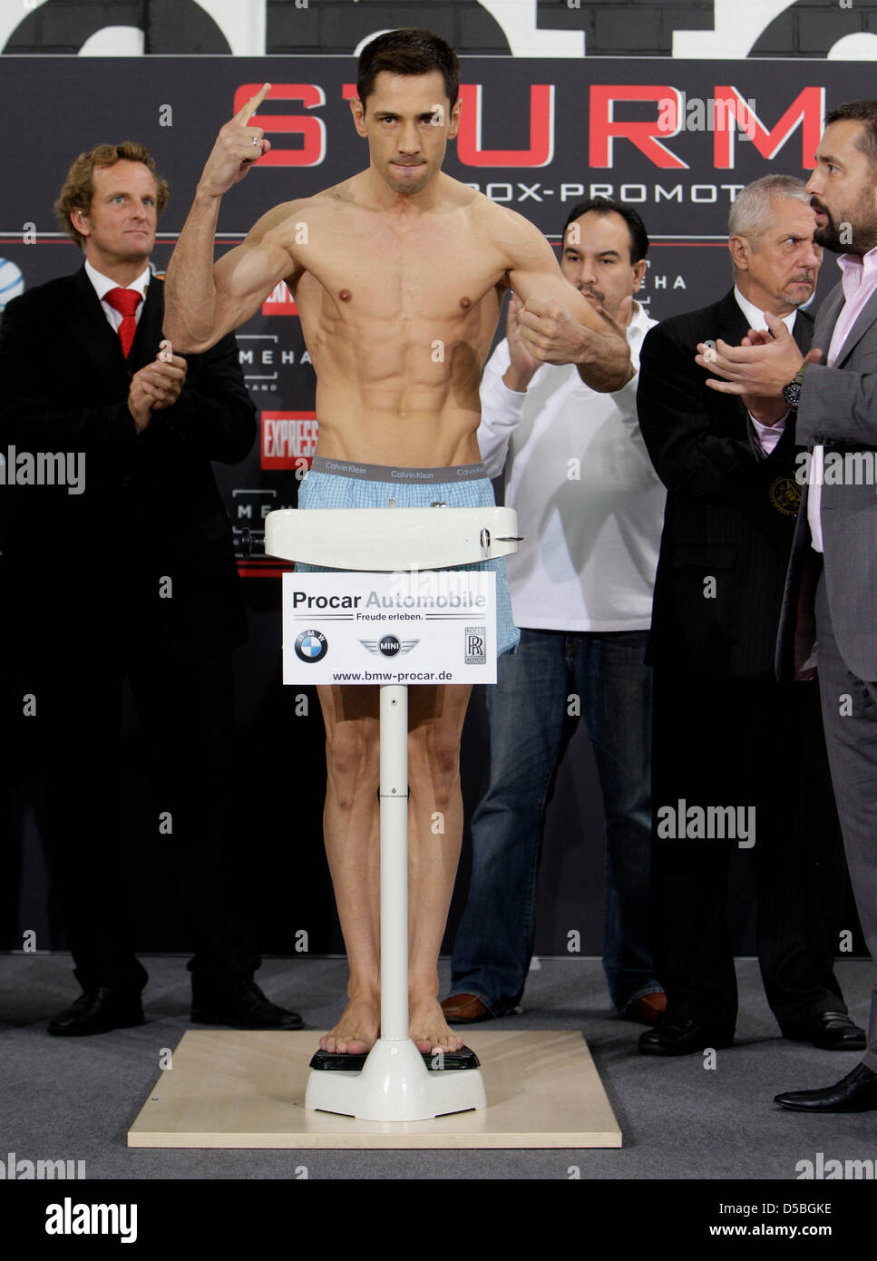 Felix Sturm stands during the official weighing at a car retailer in ...
