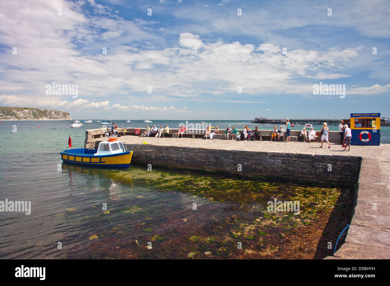 A tourist boat moored at a stone quay in Swanage in Dorset England UK ...