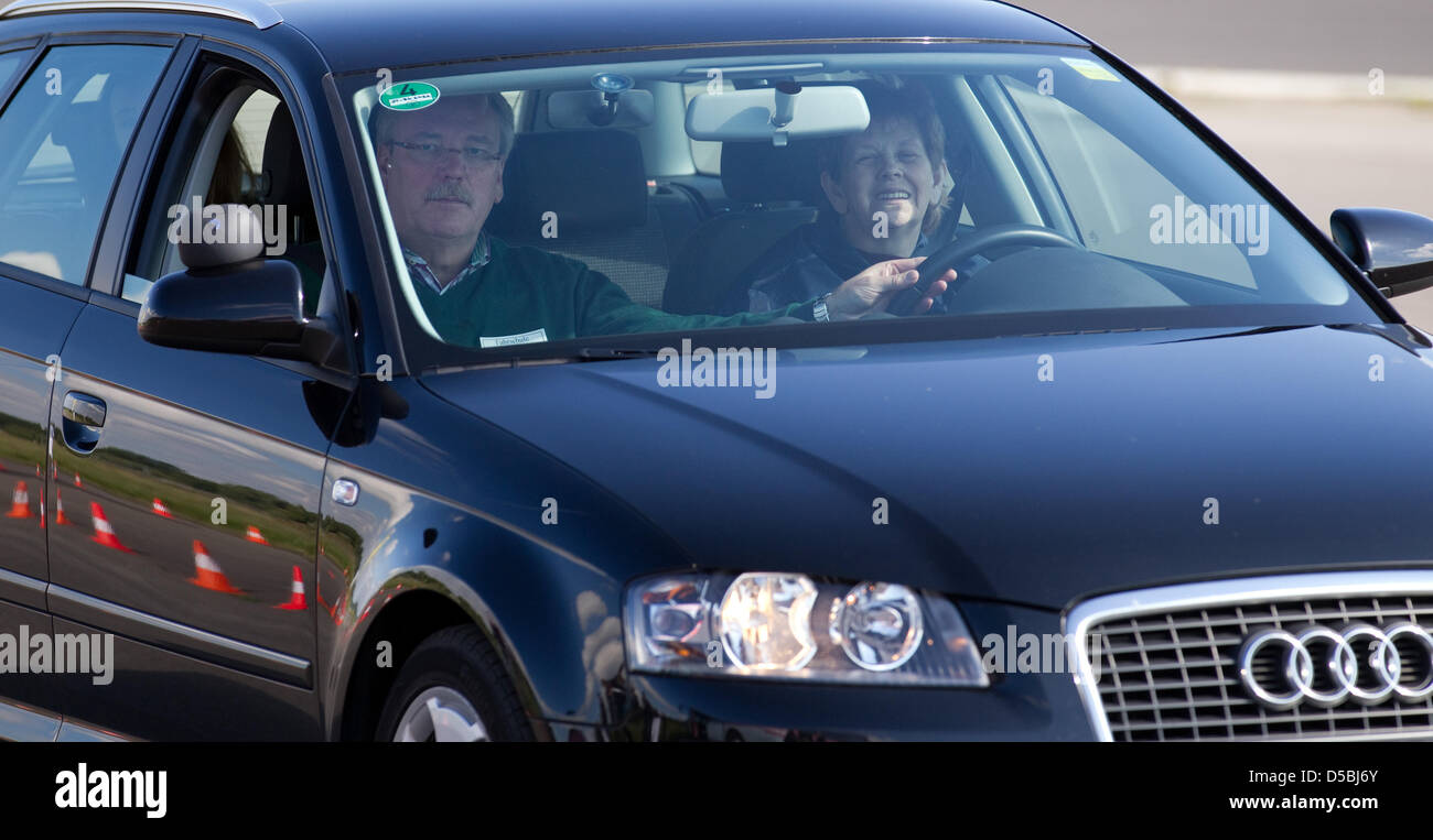 A visually impaired woman with blindman's stick next to a driving ...