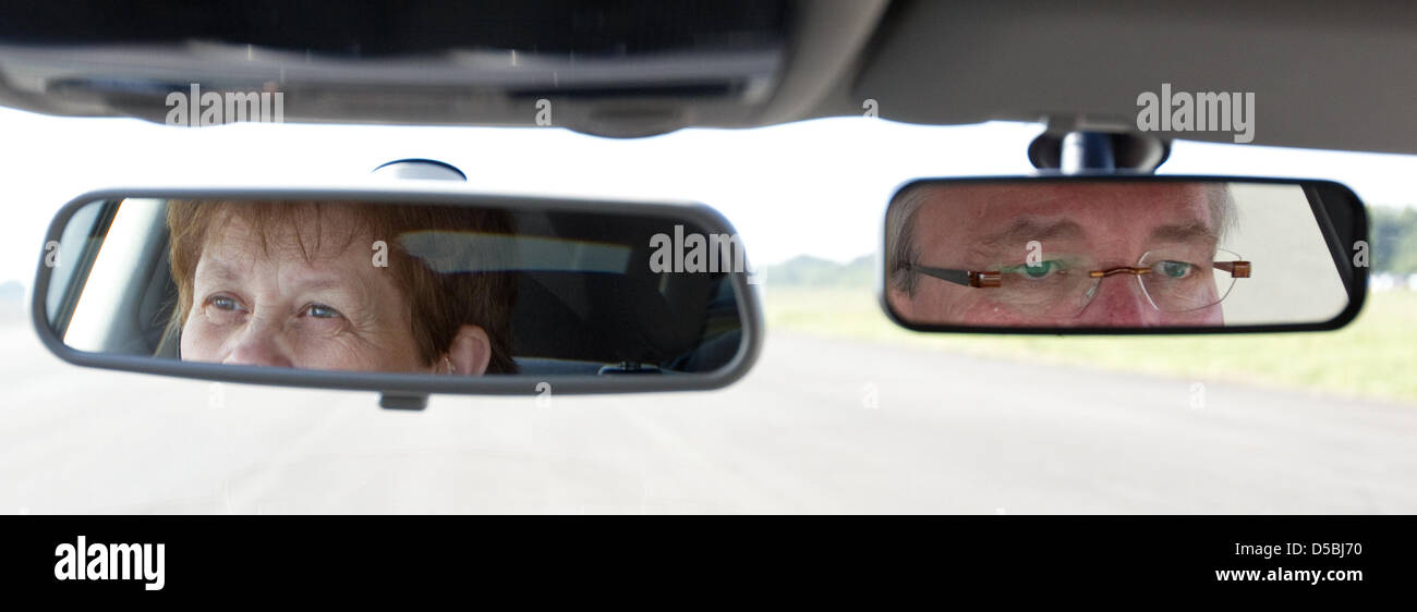 A visually impaired woman with blindman's stick next to a driving ...
