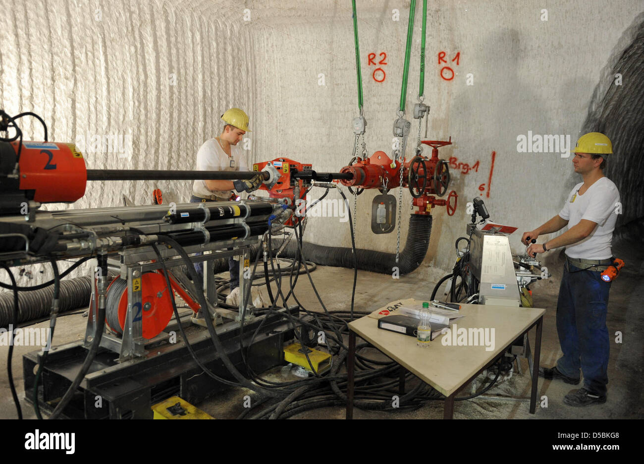 Two workers begin with the preparatory works for the clearing of the ...