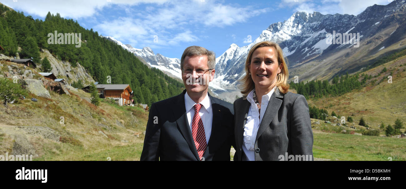 German Federal President Christian Wulff and his wife Bettina smile at ...