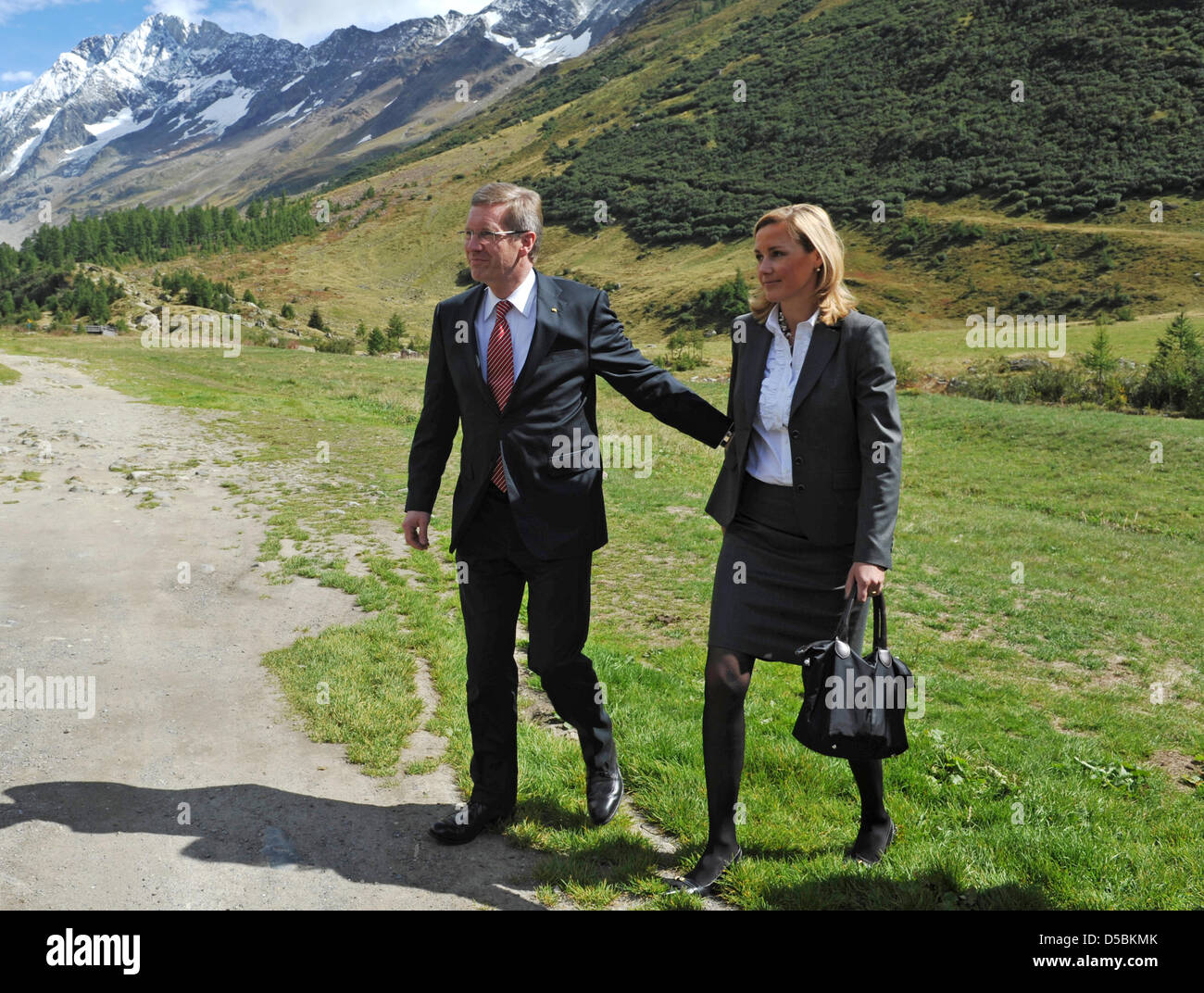 German Federal President Christian Wulff and his wife Bettina walk on ...