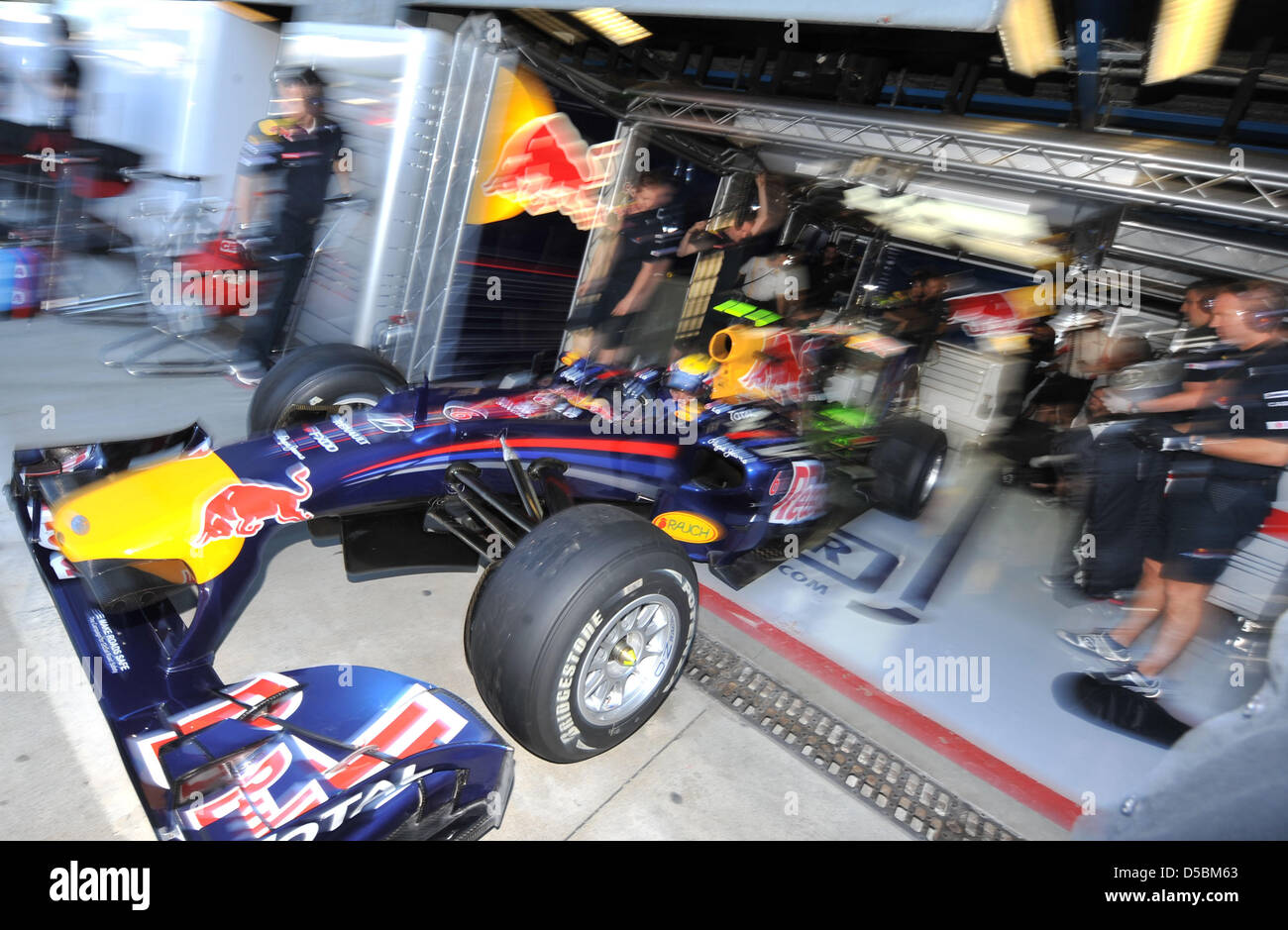 Australian driver Mark Webber of Red Bull drives out of the garage for ...