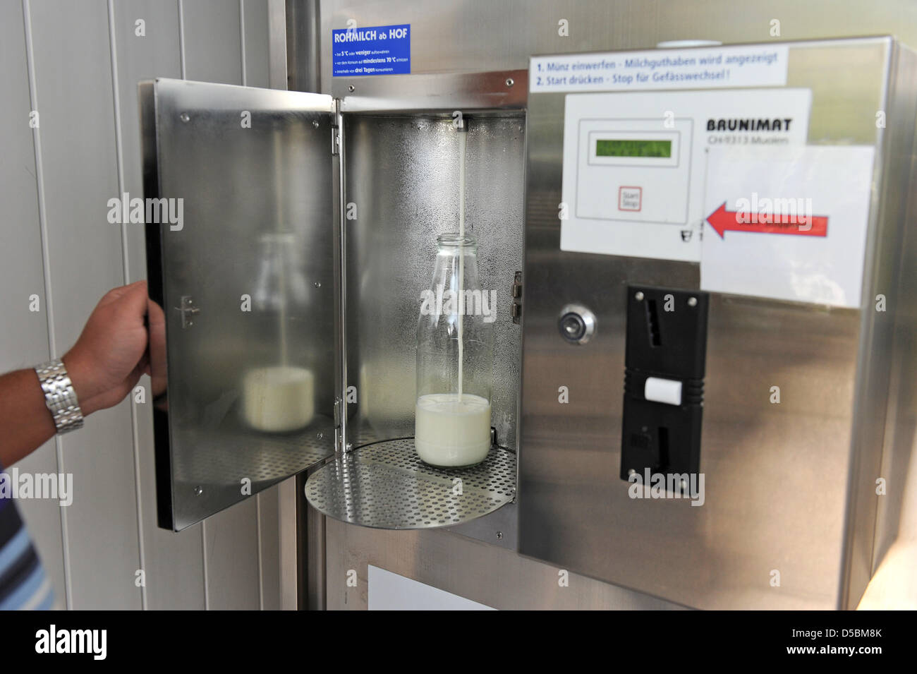 A customer fills up his bottle at a milk filling station in Schlich ...