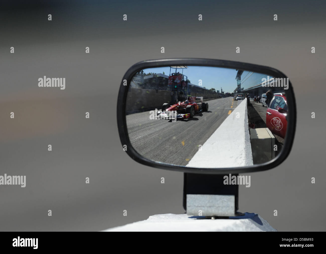 The racecar of Spanish driver Fernando Alonso of Ferrari is reflected ...