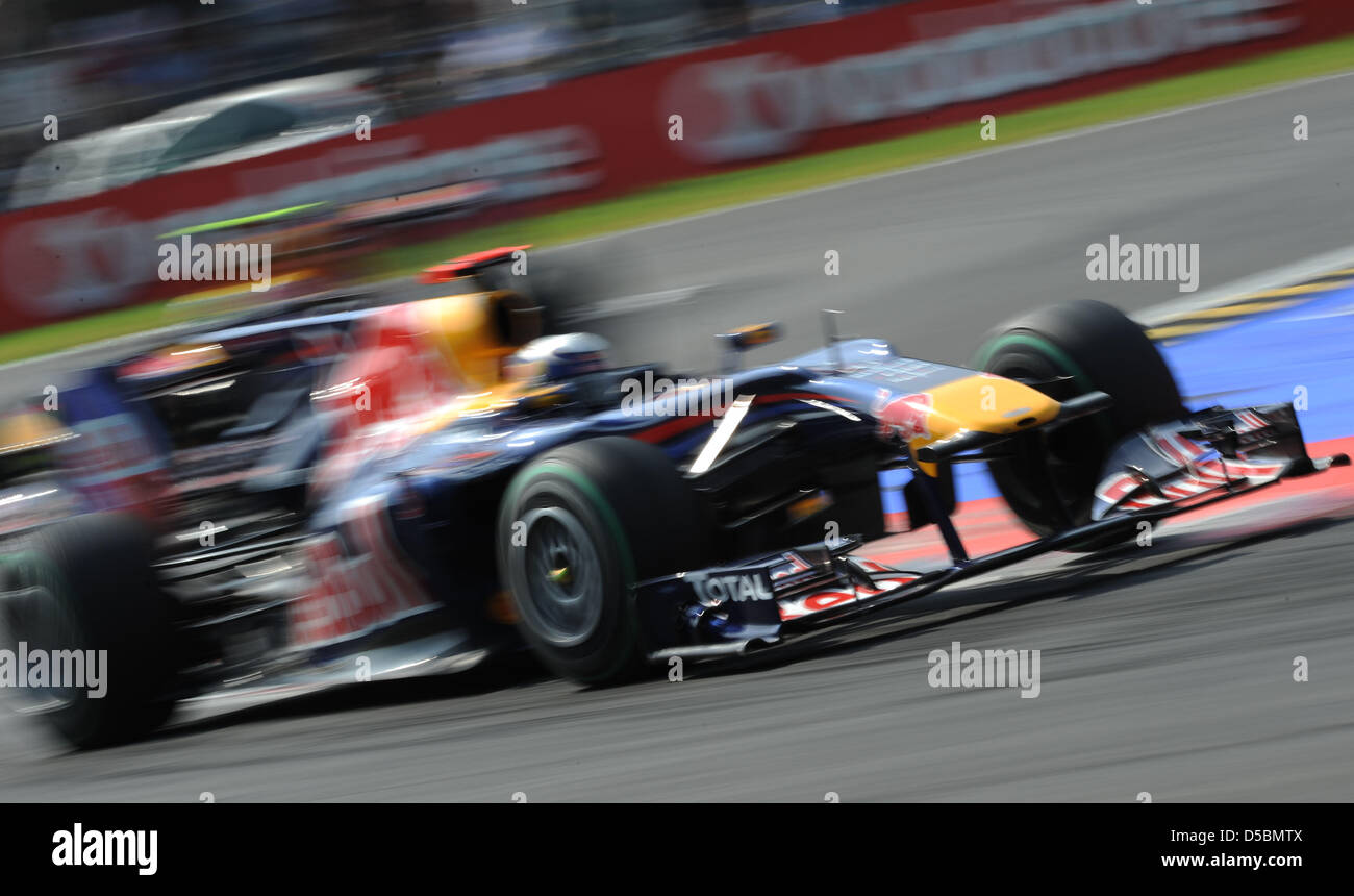 German driver Sebastian Vettel of Red Bull drives his car along a curve ...