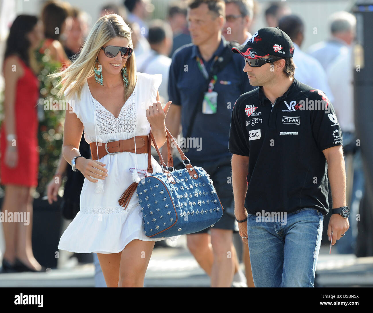 German driver Timo Glock of Virgin Racing walks through the paddock ...