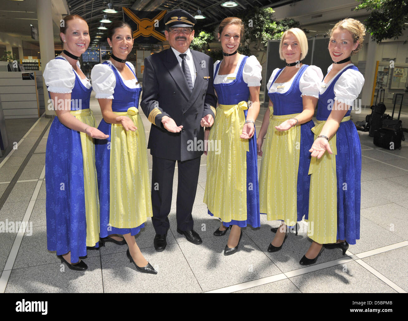 Stewardesses and captain Ludwig Grob present themselves in traditional ...
