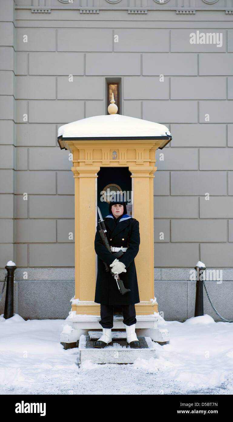 A guard stands duty in the snow outside The Royal Palace, Stockholm ...