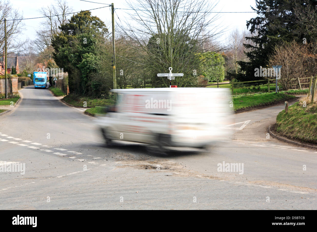A white van travelling over crossroads in the village of Ringland ...