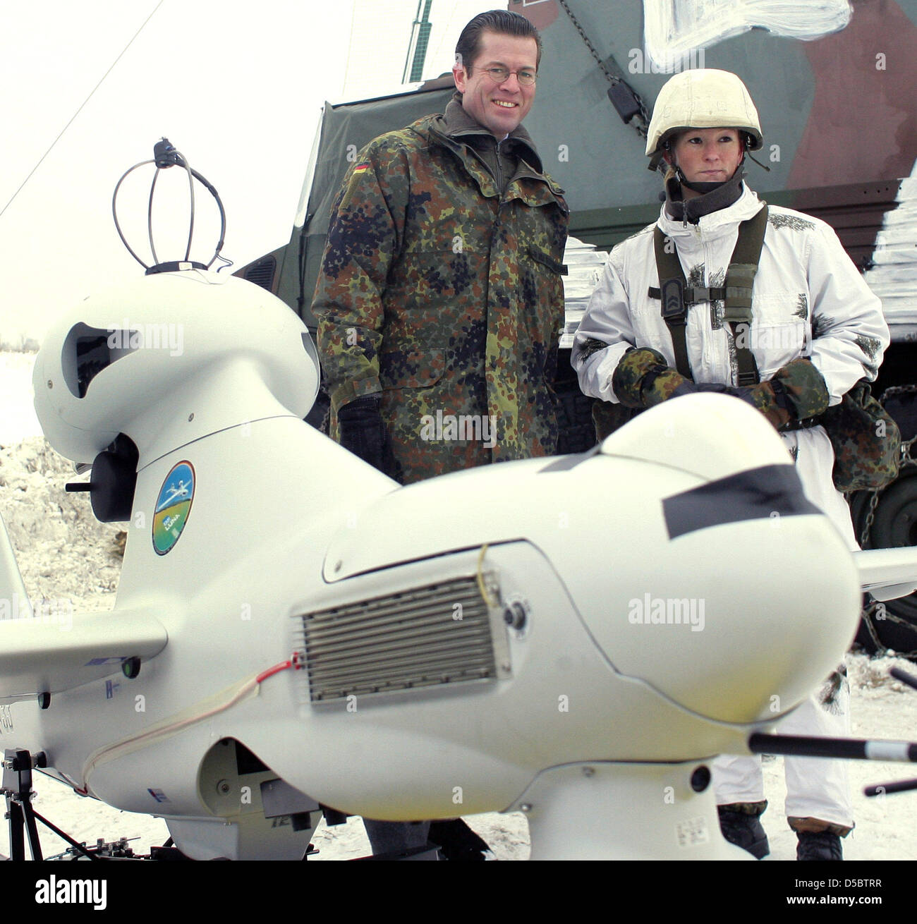 German Minister of Defence Karl-Theodor zu Guttenberg (C) inspects an ...