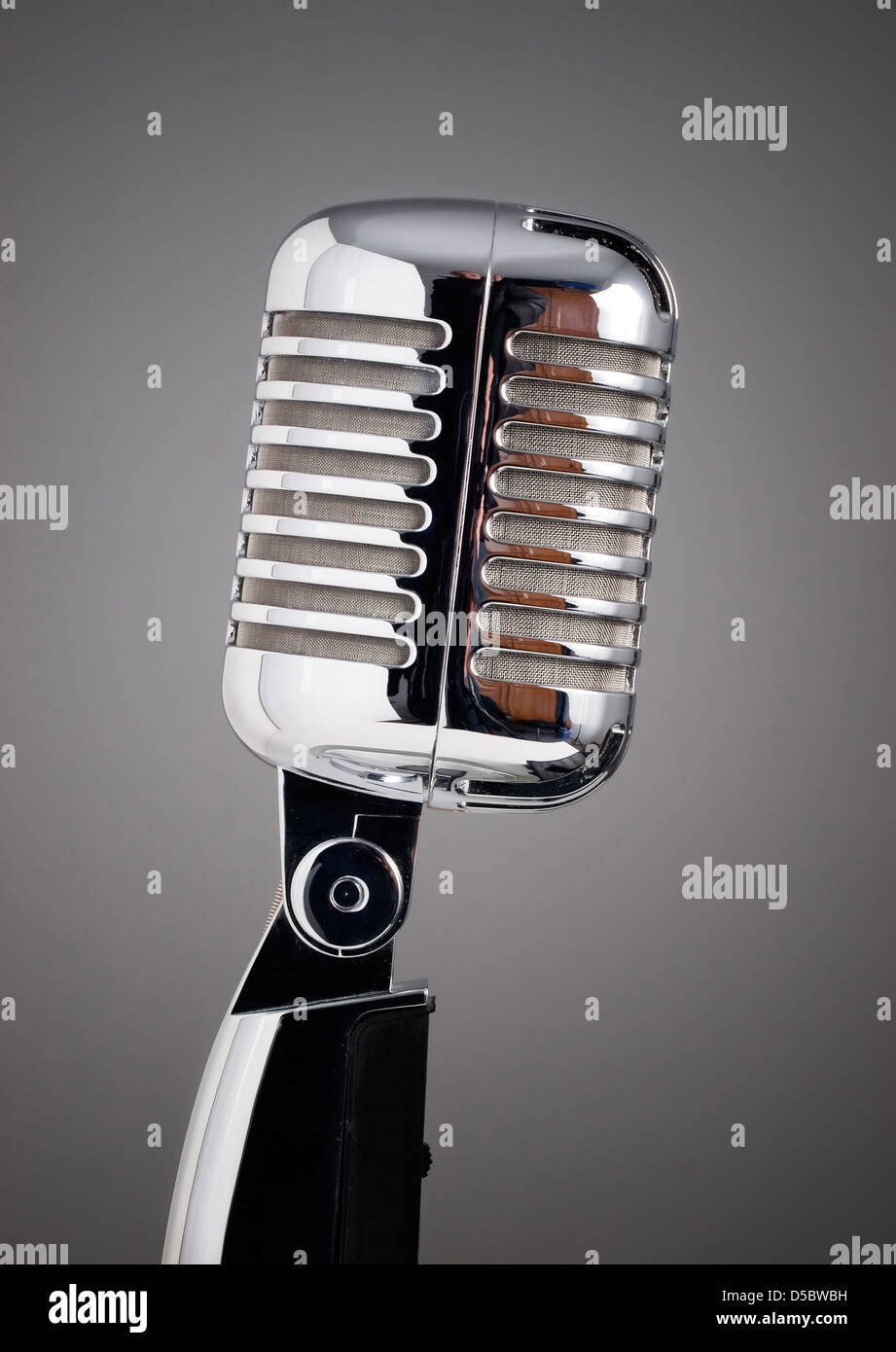 Classic metallic microphone isolated on grey background Stock Photo - Alamy