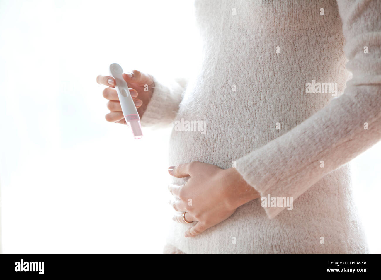 woman with pregnancy test Stock Photo - Alamy