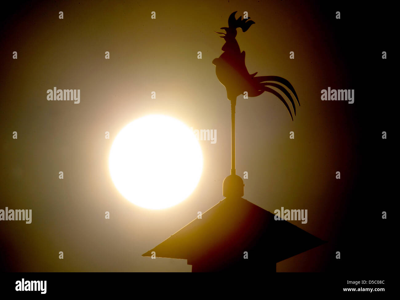 For a short period of time the sun appears behind a weathercock in ...