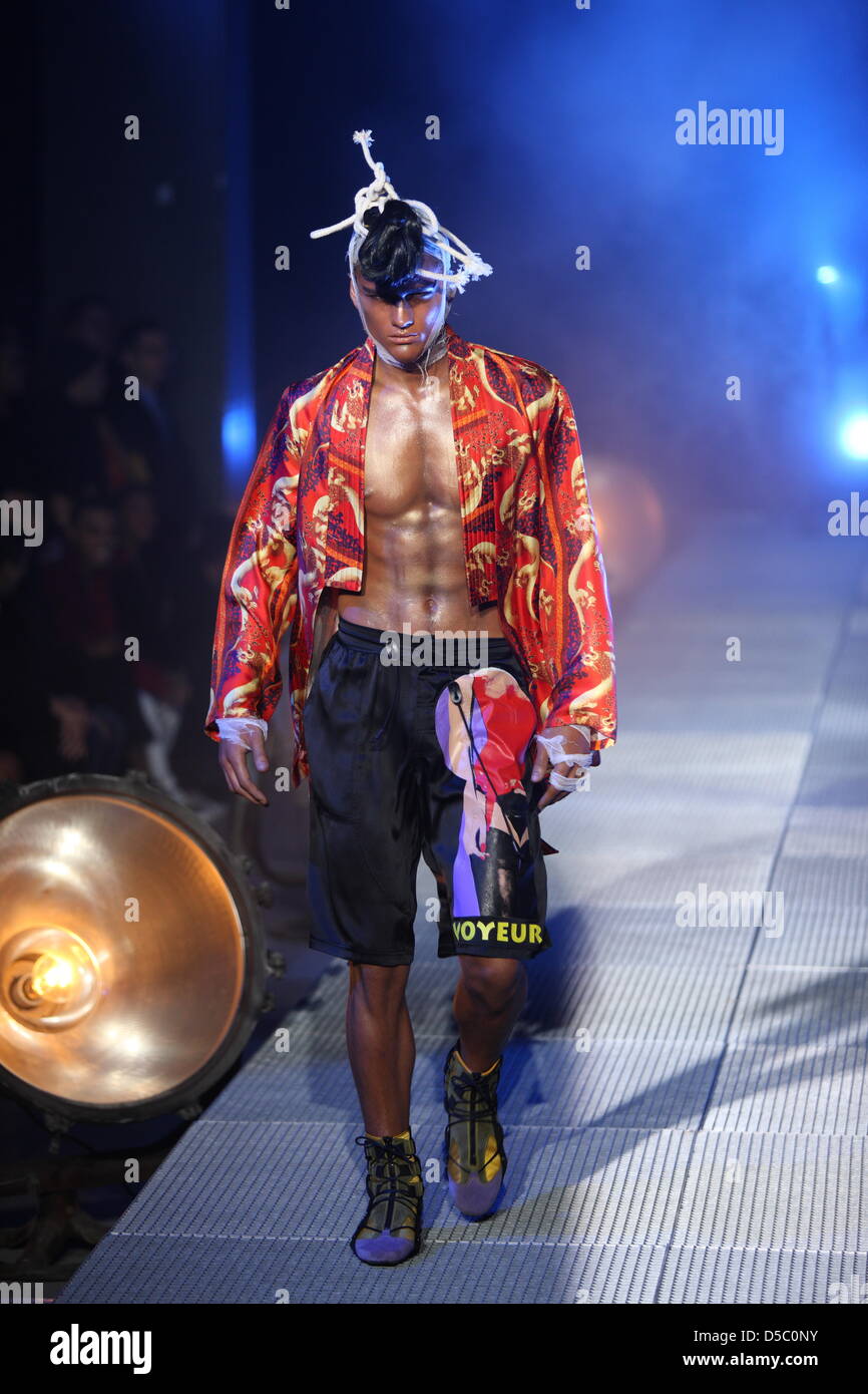 A model takes to the catwalk wearing a creation of the John Galliano's ...