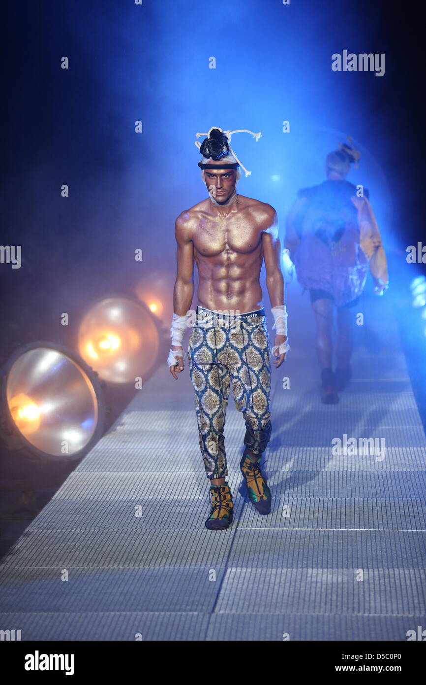 A model takes to the catwalk wearing a creation of the John Galliano's ...
