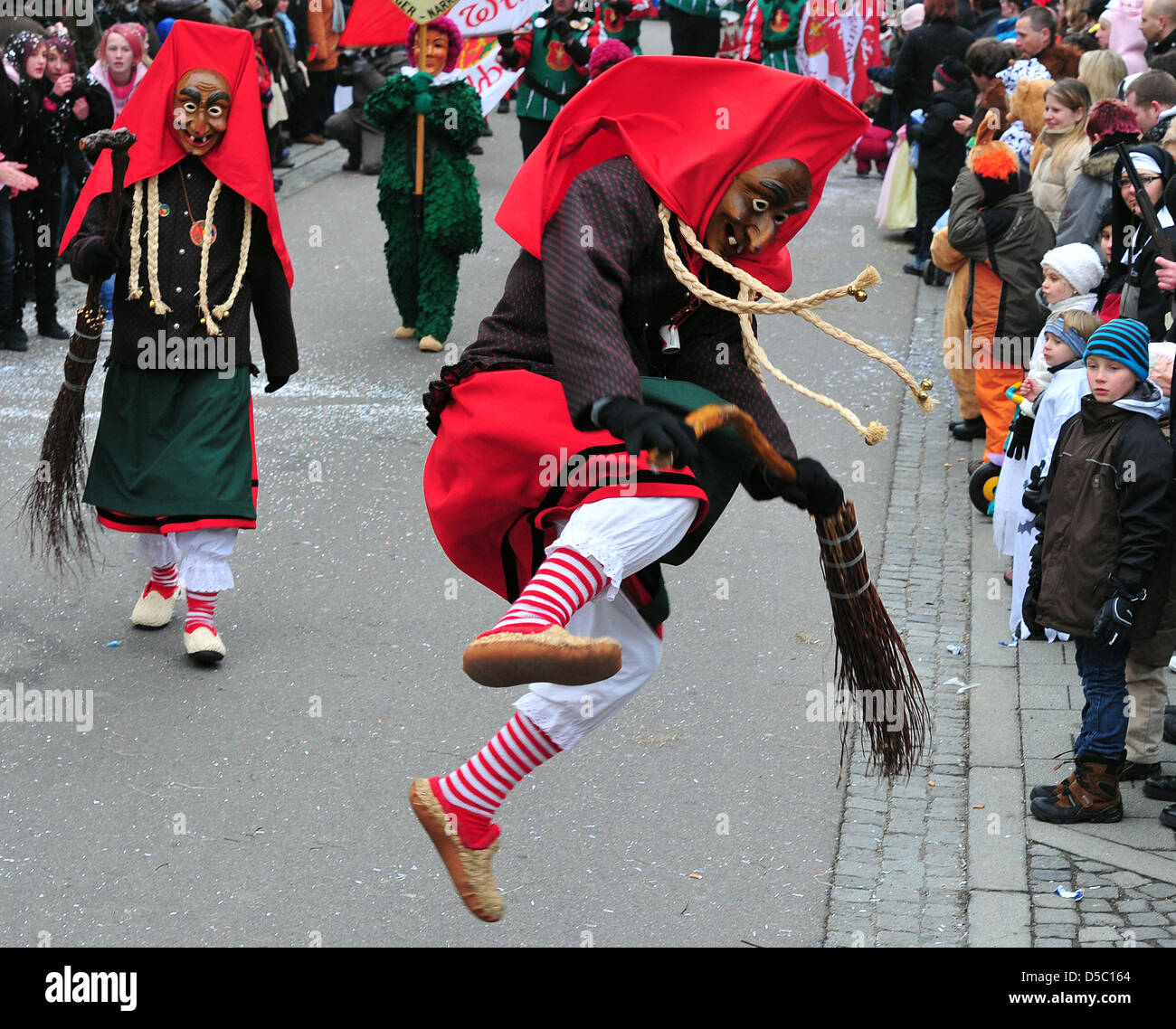 A man dressed-up as witch performs a so-called 'Fools Leap, a ceremony ...