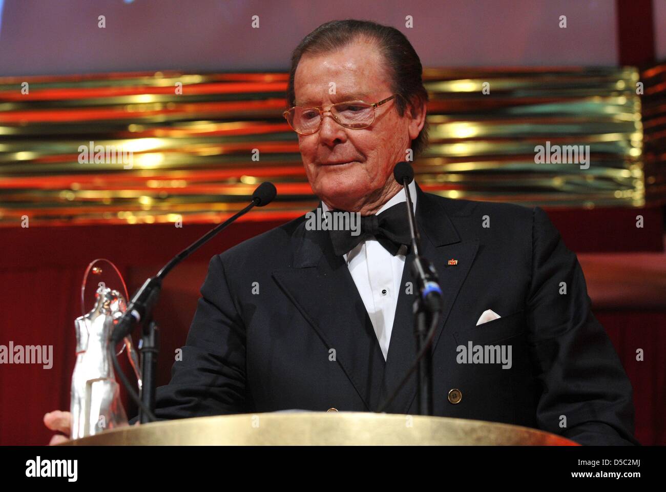British actor Roger Moore holds an acceptance speech during the award ...