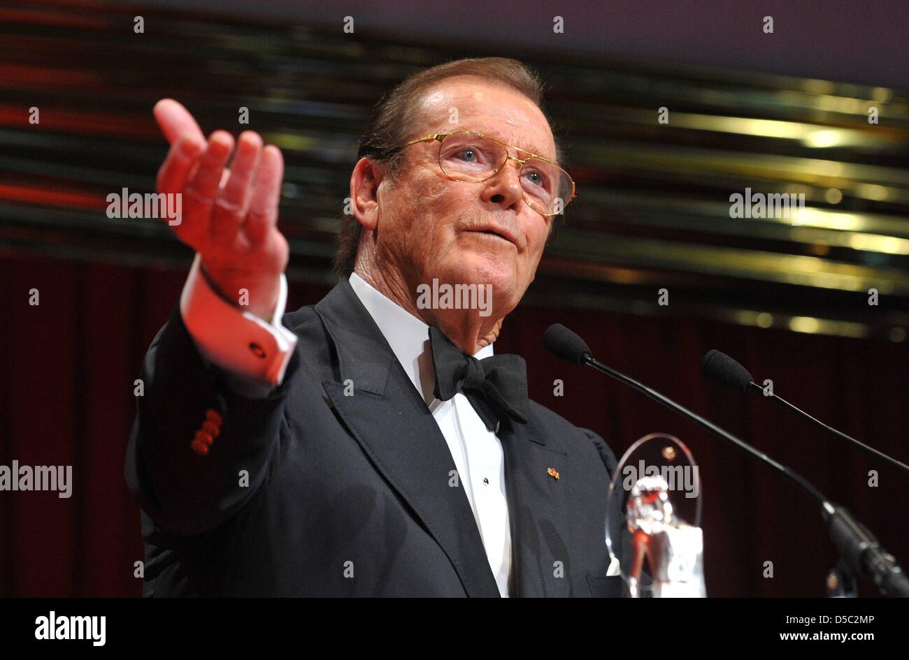 British actor Roger Moore holds an acceptance speech during the award ...