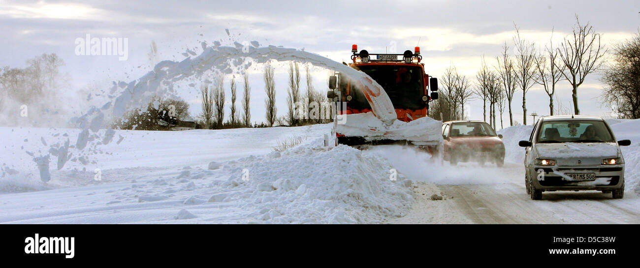 A snow blower clears snow from the German A-road B104 ('Bundesstrasse ...