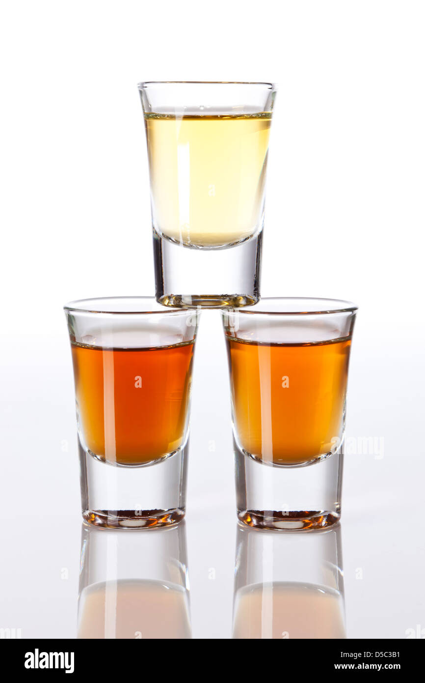 Stack of three shot glasses, with differently tinted liquids Stock ...