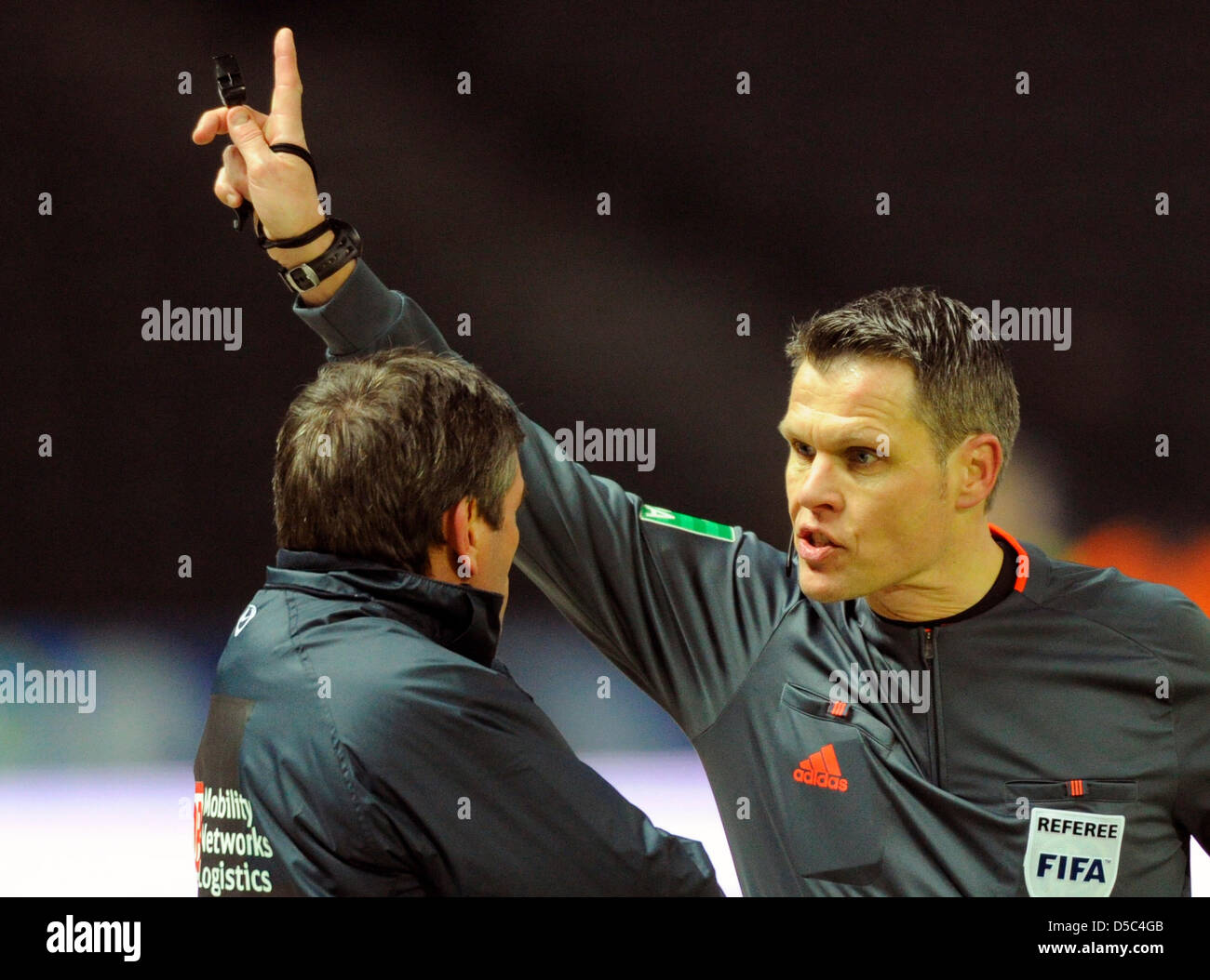 Berlin's head coach Friedhelm Funkel (L) is warned by referee Michael ...