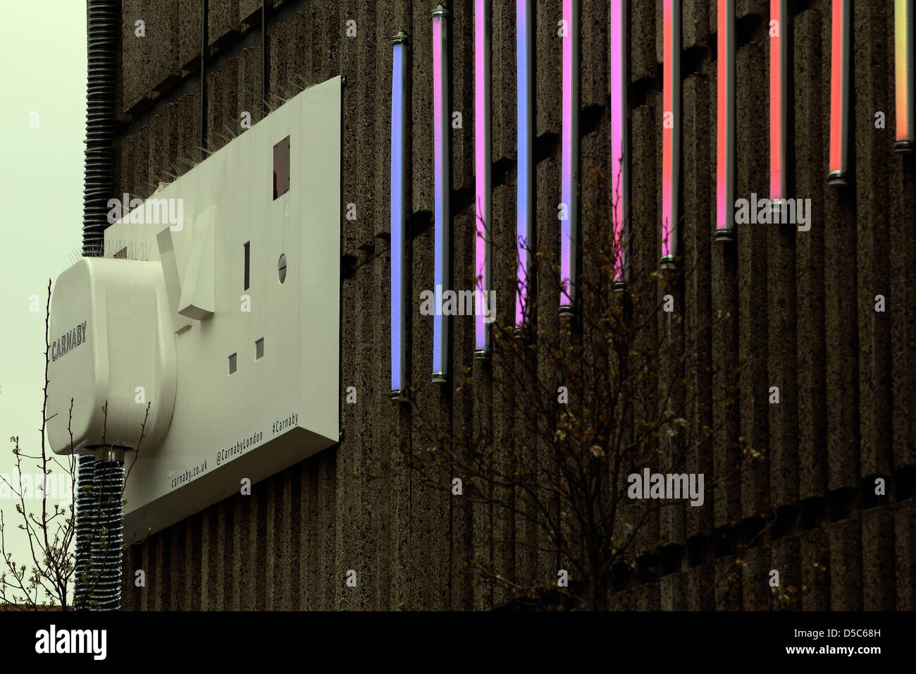 London giant plug on wall Soho near Carnaby Street Stock Photo - Alamy