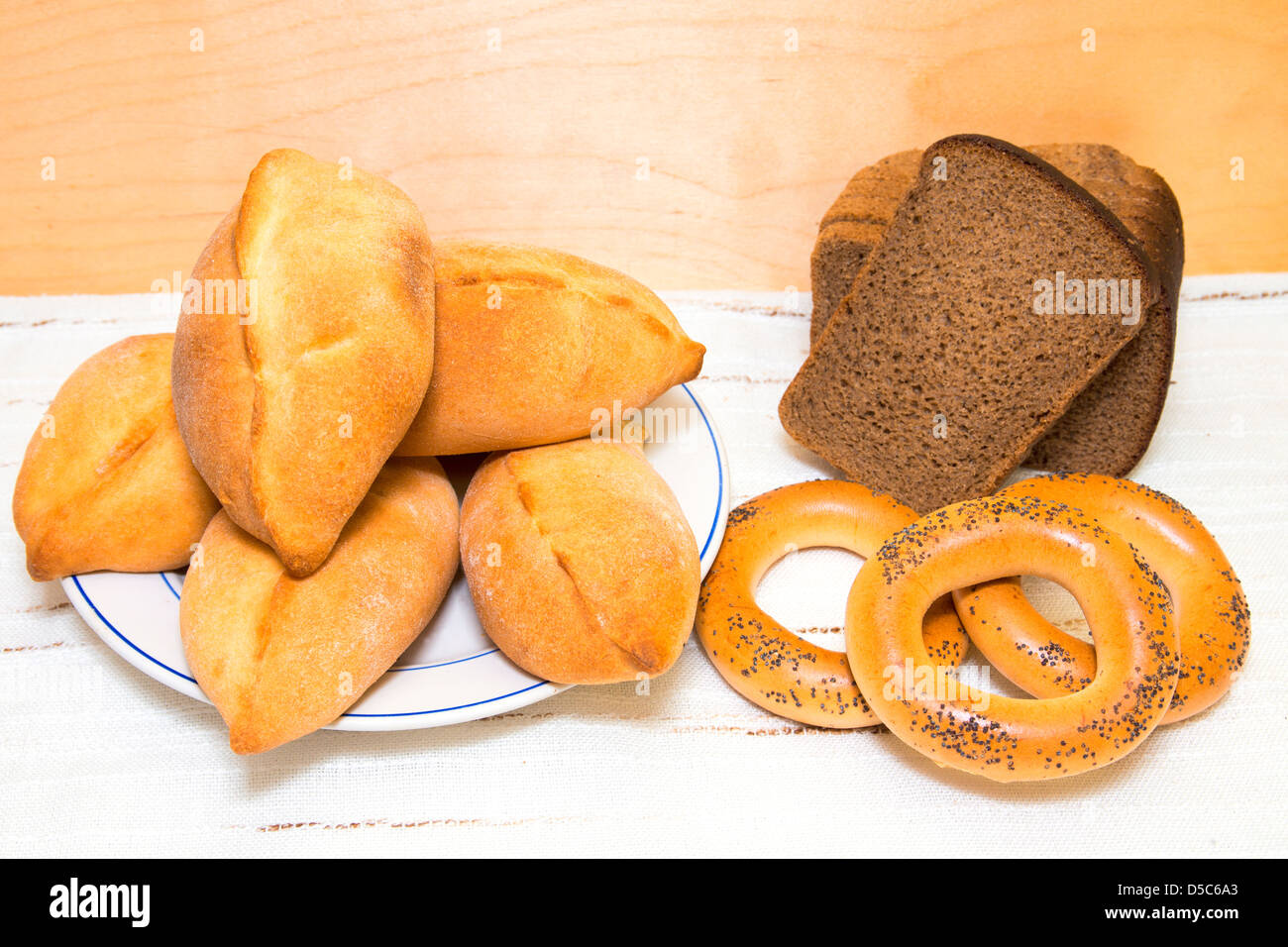 Traditional pastries and bread over wooden and linen background Stock ...