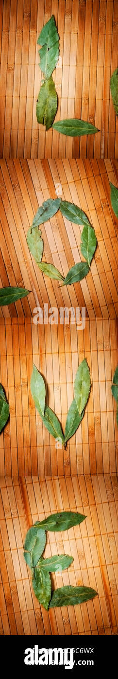 Word love written with leaves on bamboo background in vertical ...