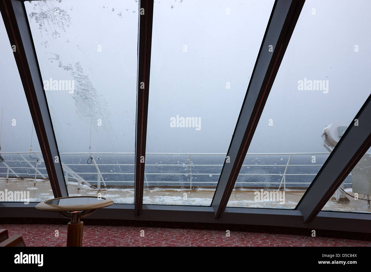 looking out through ship observation deck window at cold norwegian ...