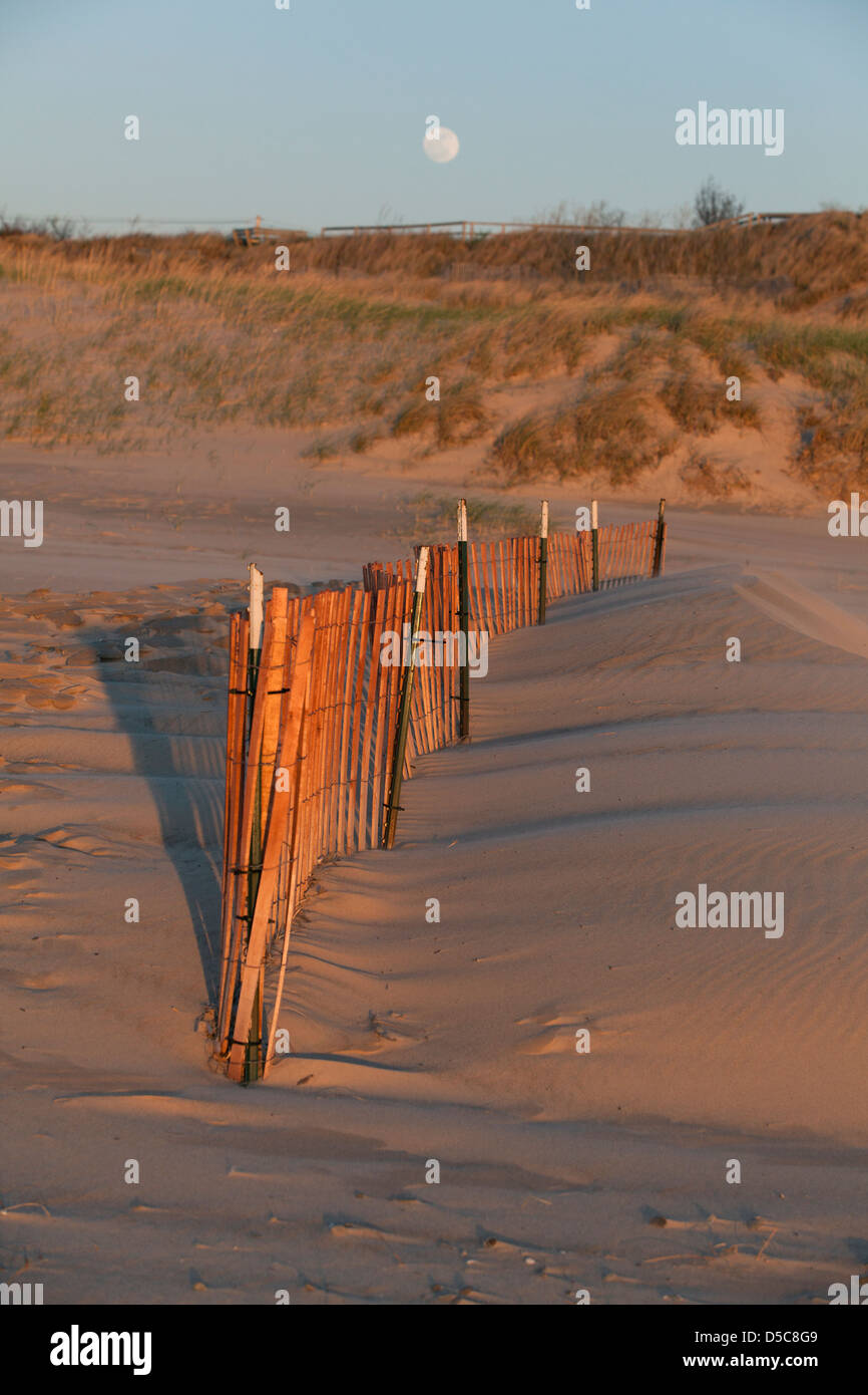A fence and the moon at sunset at Michigan Lake, New Buffalo Beach, USA ...