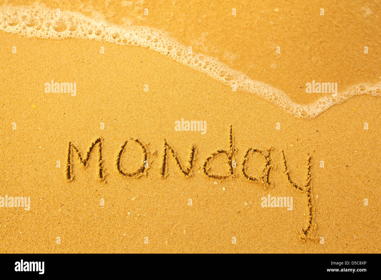 Monday - written in sand on beach texture - soft wave of the sea Stock ...
