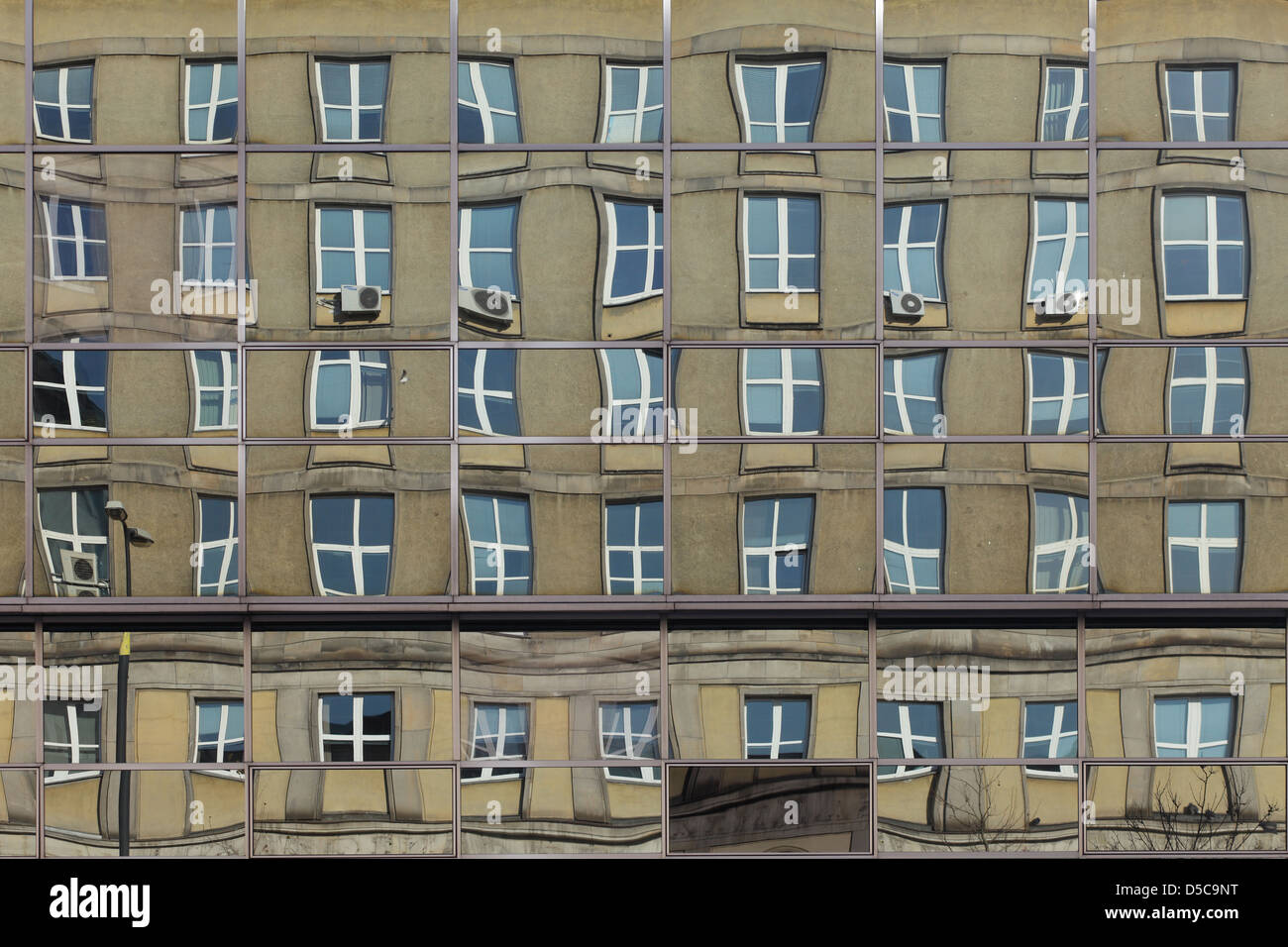 Warsaw, Poland, mirroring an old building in the glass facade of a ...